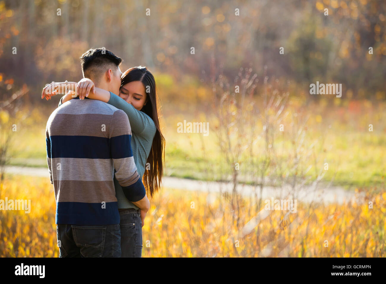 A Young Asian Couple Enjoying A Romantic Time Together Outdoors In A ...