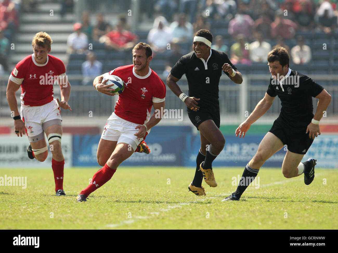 Wales' Ifan Evans (second left) charges through the New Zealand defence ...