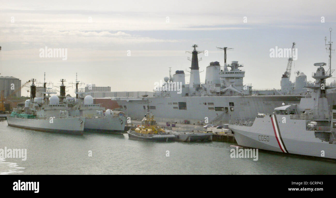 Two Royal Navy Type 42 destroyers tied up alongside aircraft carrier ...