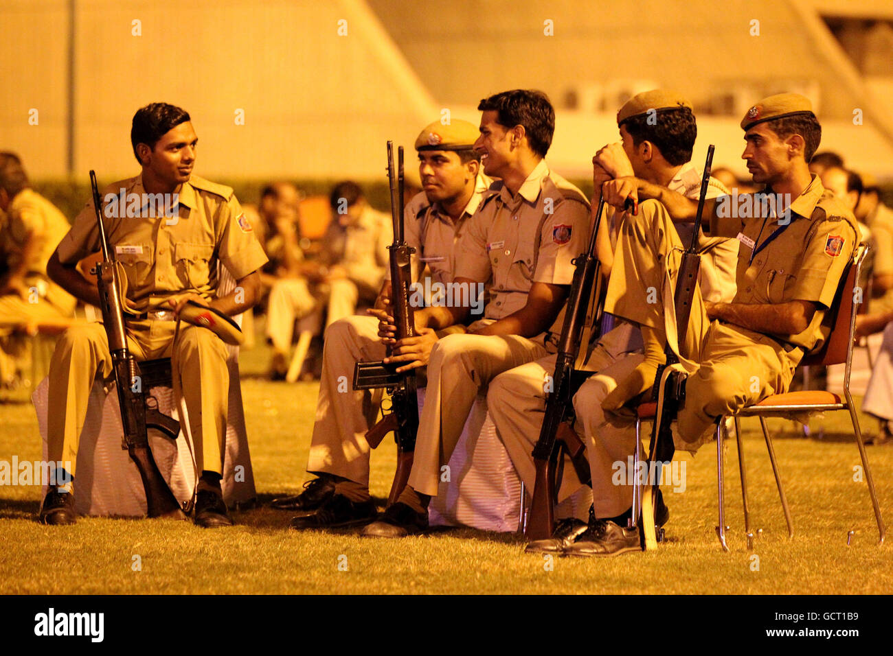 Police Officers watch the 2010 Commonwealth Games opening ceremony on a ...