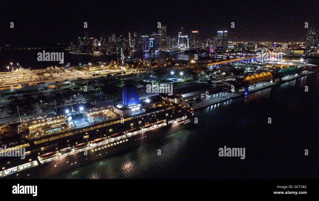 Aerial view of the Port of Miami with the city lights of Miami in the ...