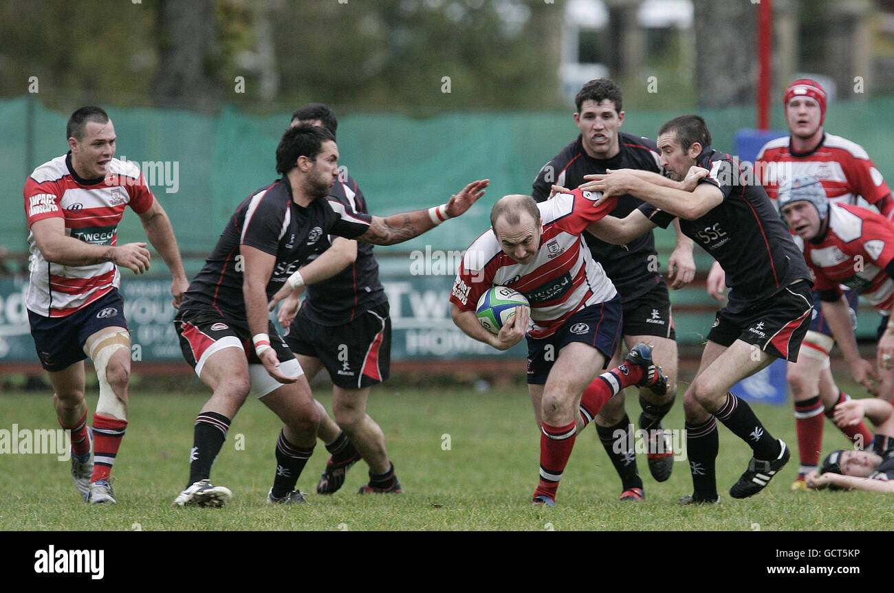 Peebles' Andrew Moore breaks the tackle from Biggar's Simeon James and ...