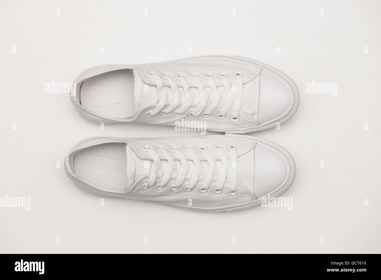 White sneakers on a white background Stock Photo - Alamy