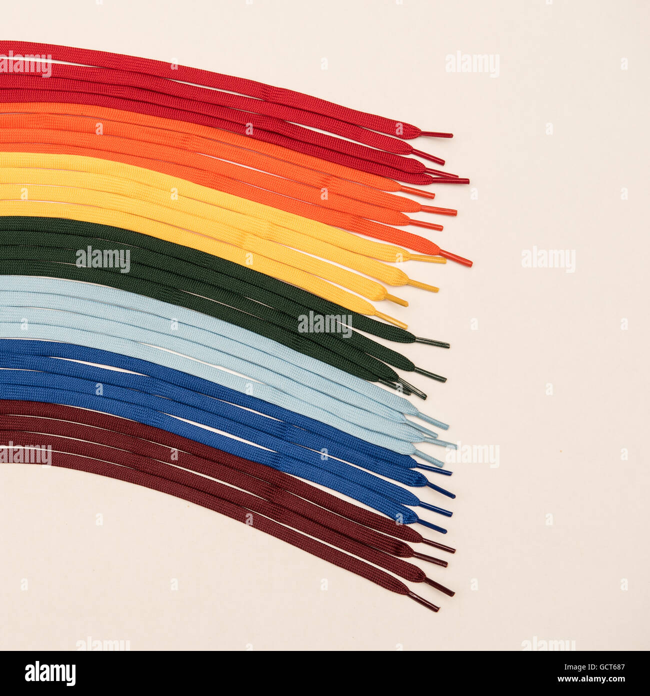 Rainbow coloured laces on a white background Stock Photo - Alamy