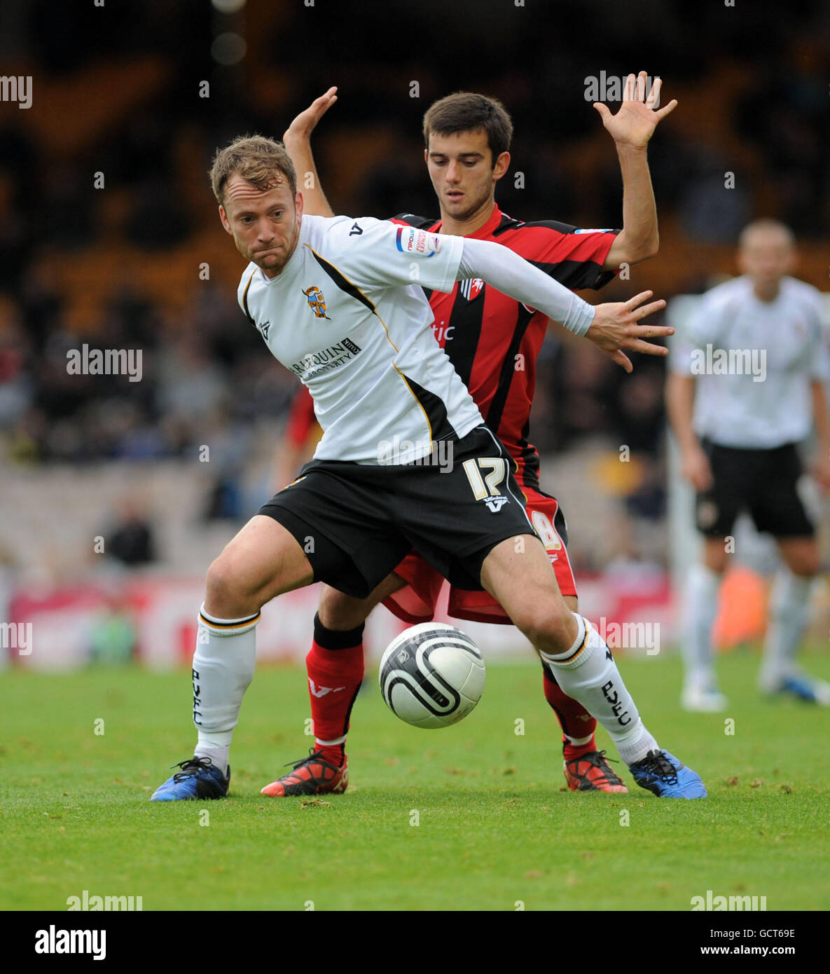 Port Vale's Sean Rigg of (left) competes with Gillingham's Mark Bentley ...