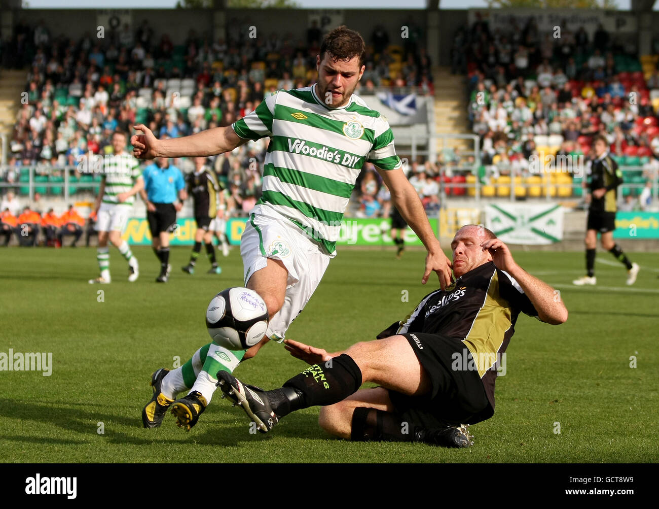 Shamrock Rover's James Chambers (left) receives a strong tackle Stock ...