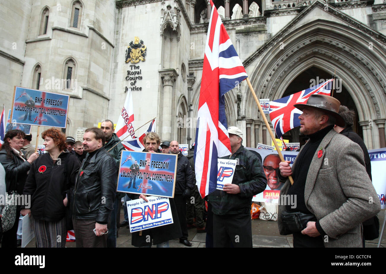 Supporters of the British National Party stand outside the Royal Courts ...