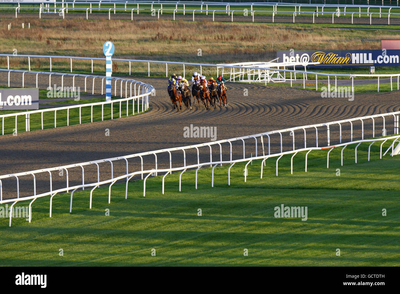 Runners and riders in action at kempton park racecourse hi-res stock ...