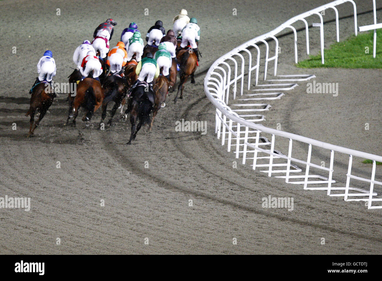 Runners and riders in action at kempton park racecourse hi-res stock ...