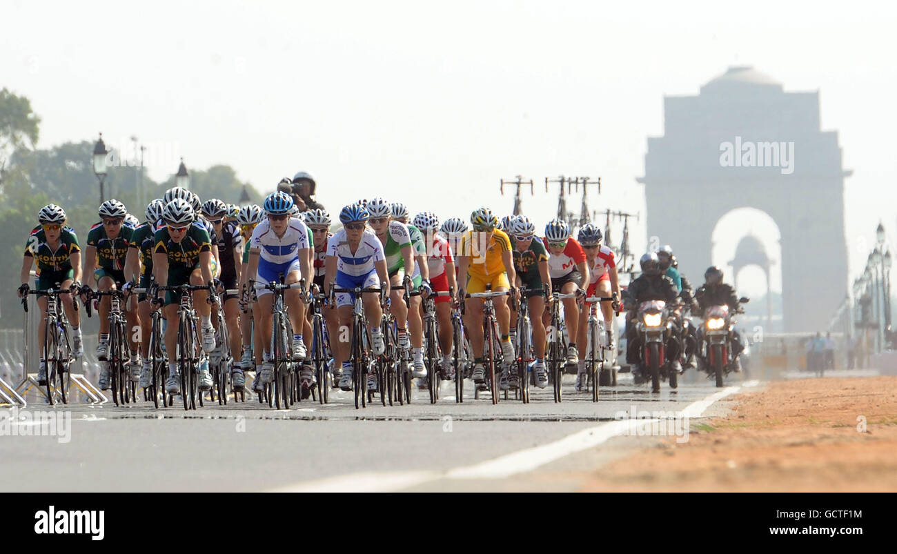 India Gate is seen in the background as cyclists ride along Rajpath as ...