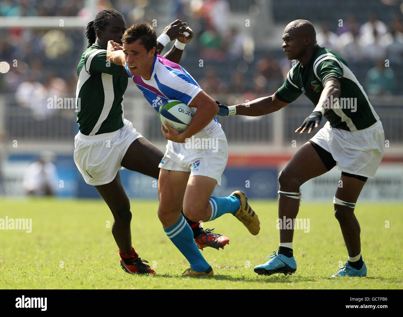 Scotland's Lee Jones (centre) escapes pressure from Guyana in action in ...