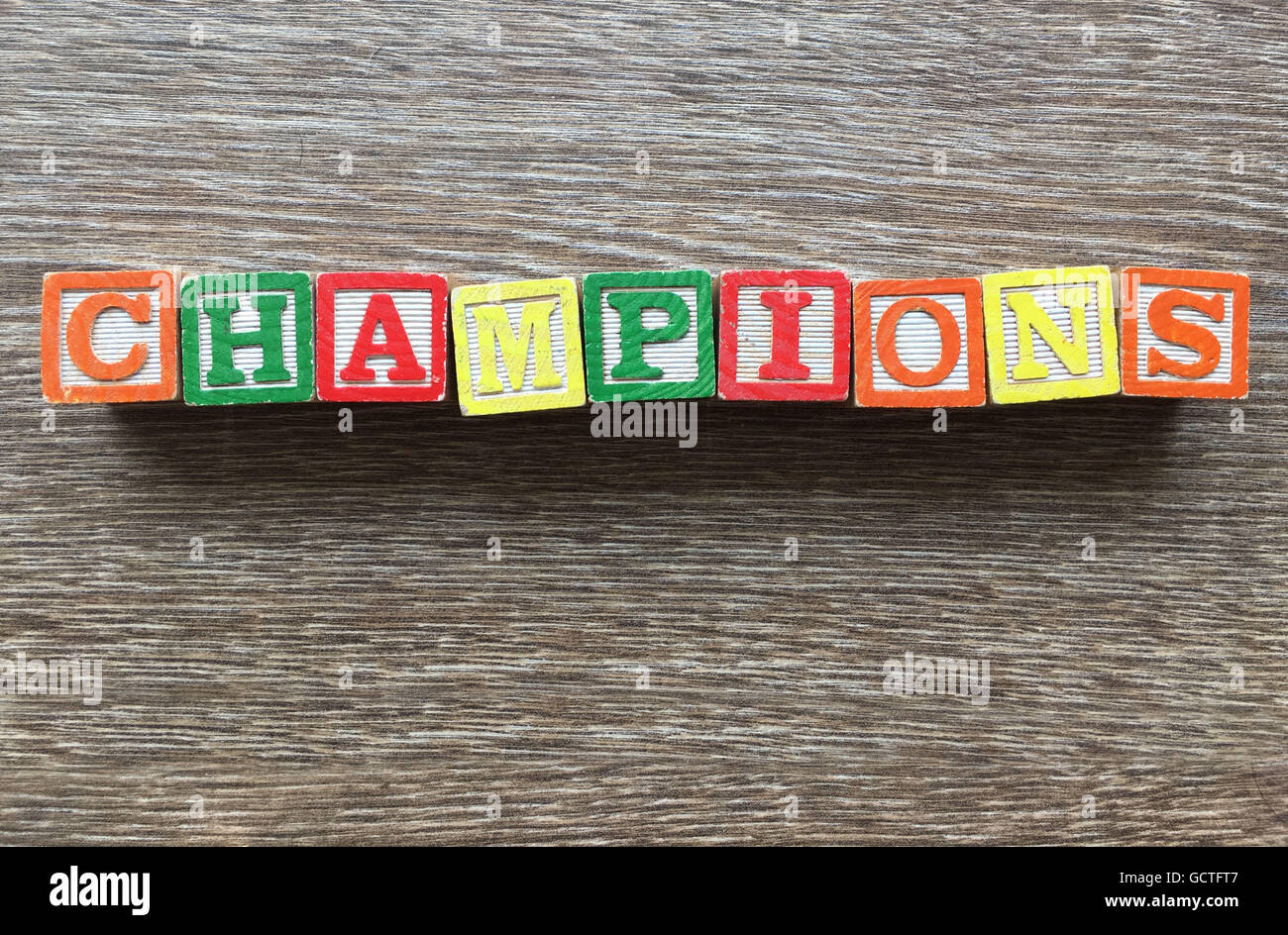 CHAMPIONS word written with wood block letter toys Stock Photo - Alamy