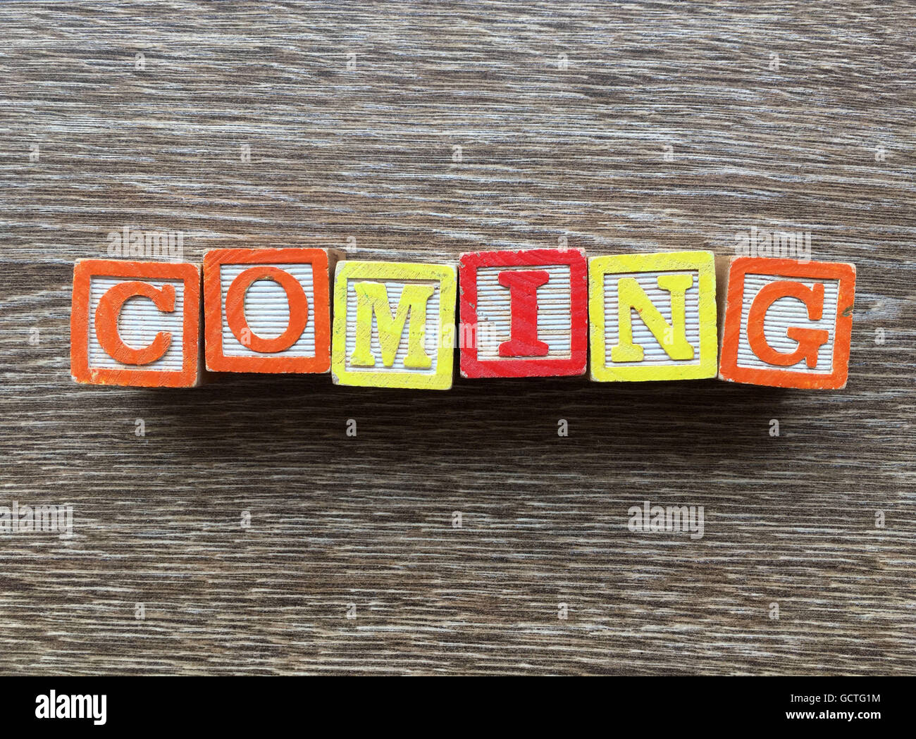 COMING word written with wood block letter toys Stock Photo - Alamy