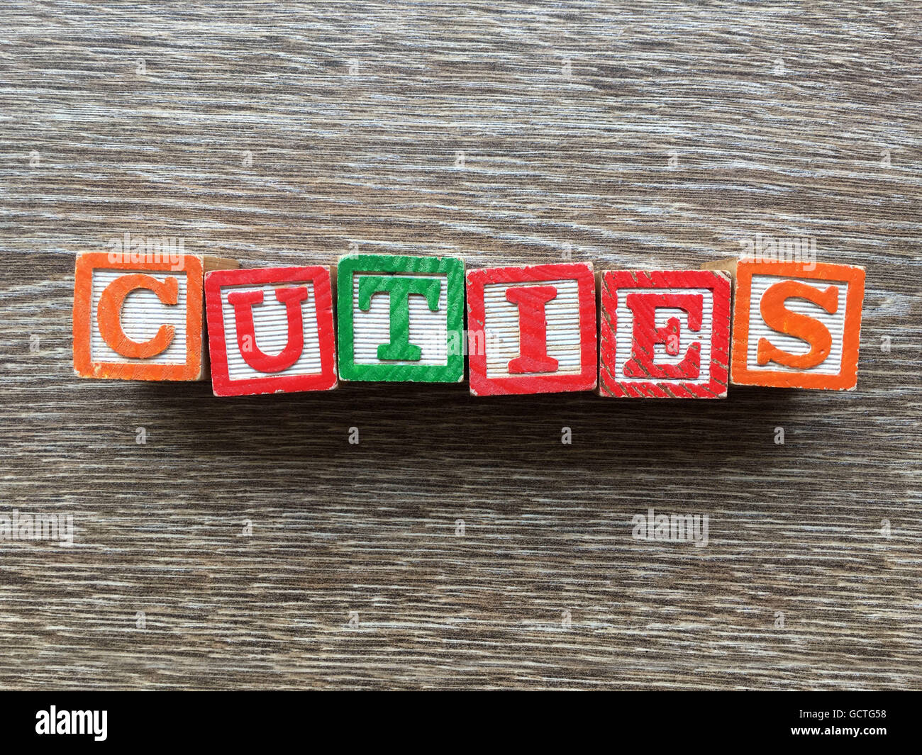 CUTIES word written with wood block letter toys Stock Photo - Alamy