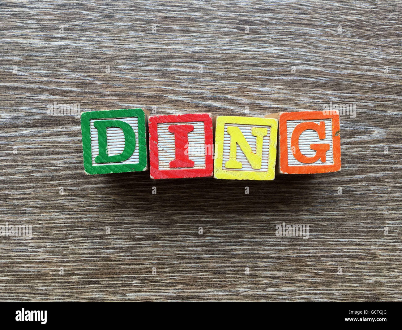 DING word written with wood block letter toys Stock Photo - Alamy