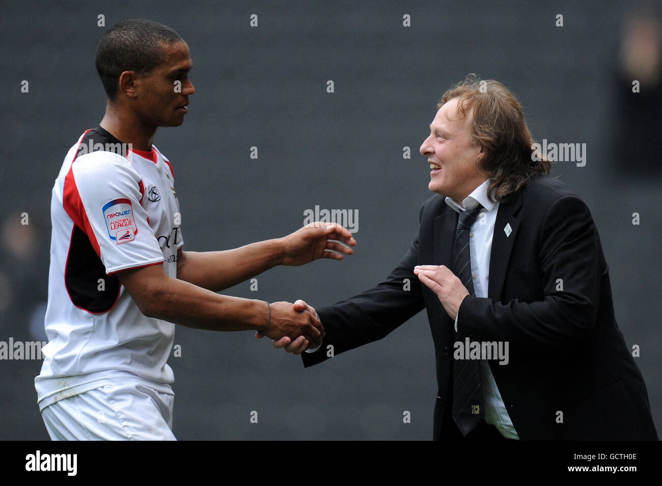 Milton Keynes Dons' chairman Pete Winkelman (right) shales hands with ...
