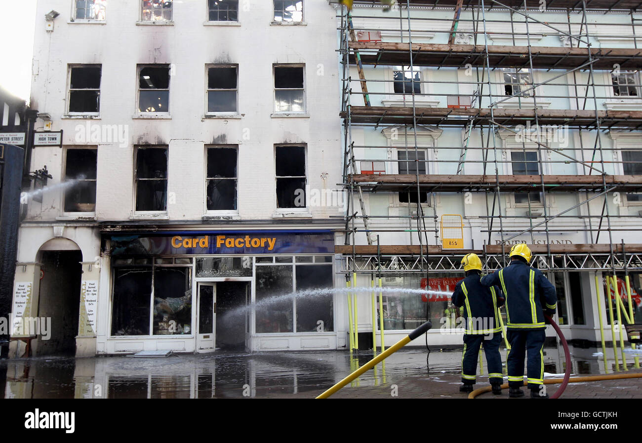 Fire crews work to put out a fire in the Card Factory shop which also ...