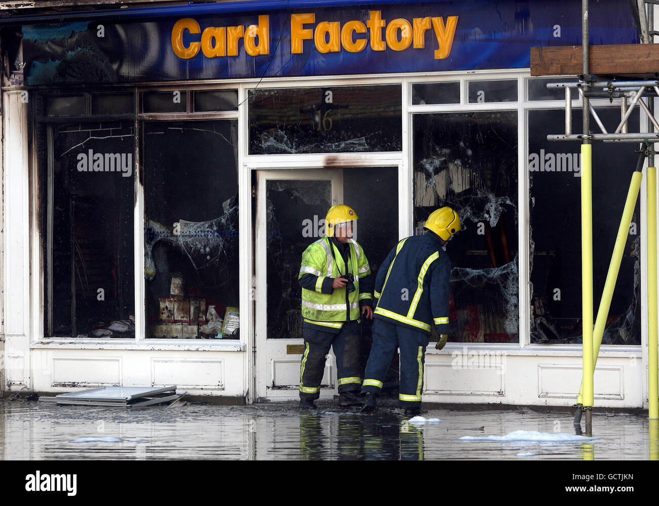 Fire crews inspect the damage to the Card Factory shop after a fire ...