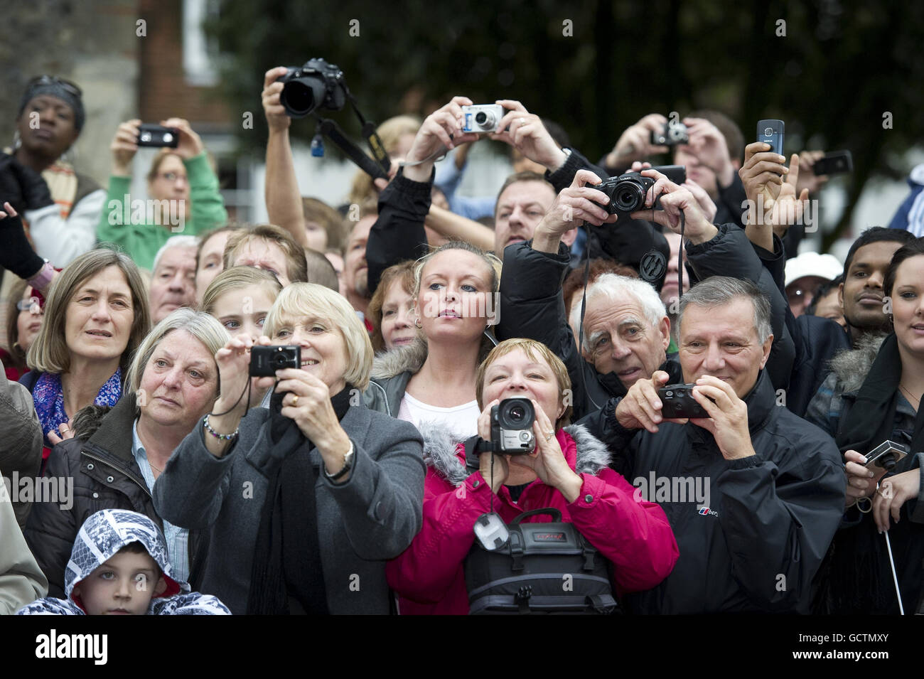 The crowd gathers to see Queen Elizabeth II during a walkabout at ...