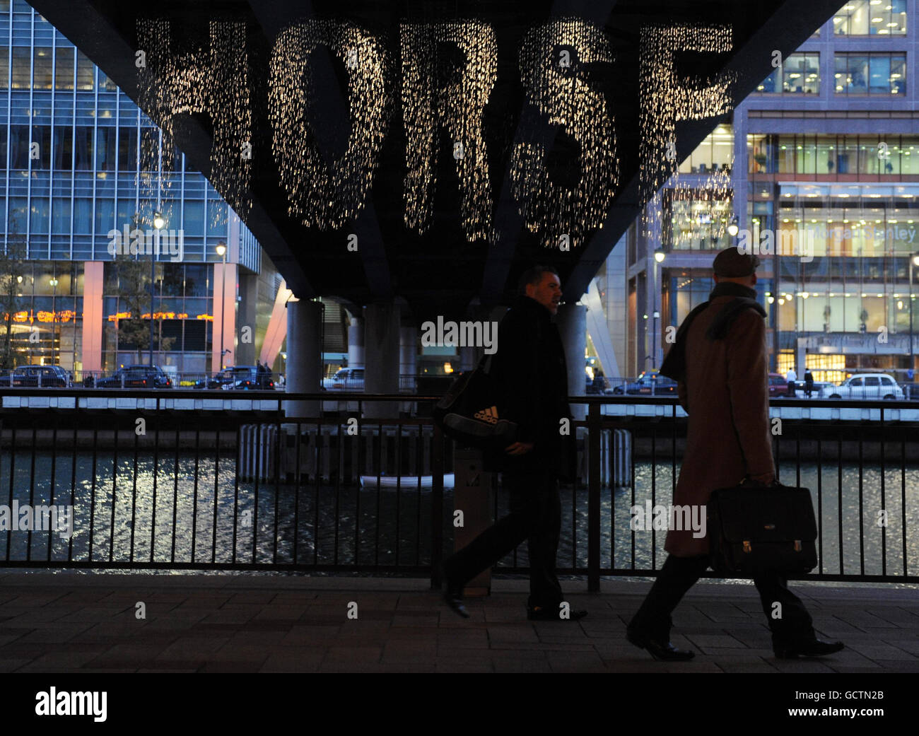 Commuters pass a waterfall of words which depicts the most commonly ...