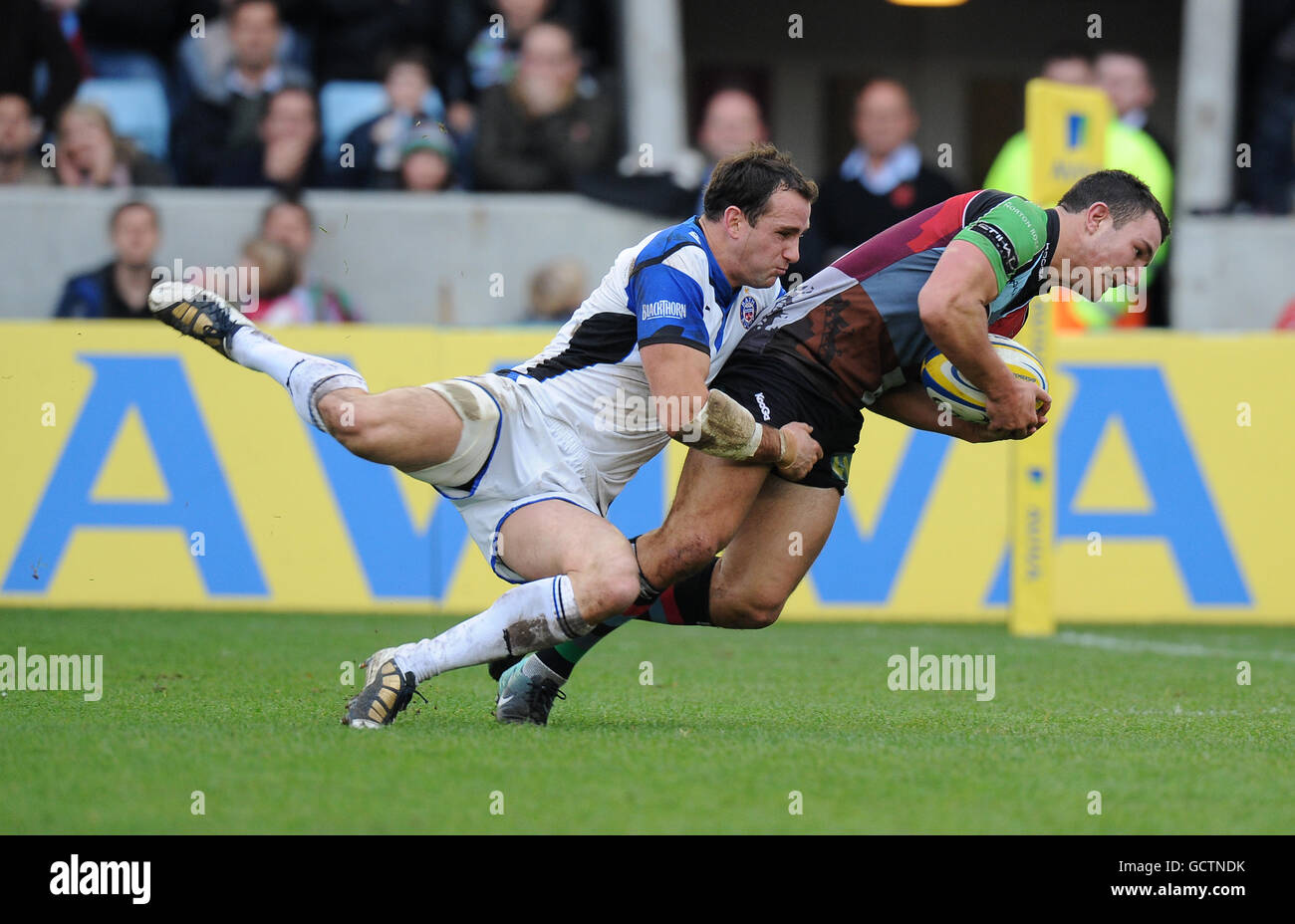 Harlequins george lowe tackled by bath rugbys matt carraro hi-res stock ...