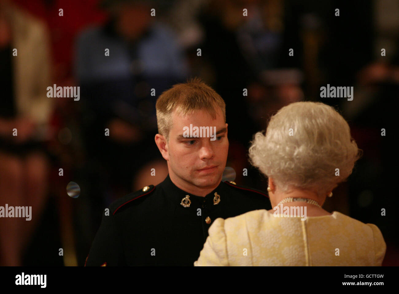 Queen Elizabeth II presents Lance Corporal Daniel Fletcher, of the ...
