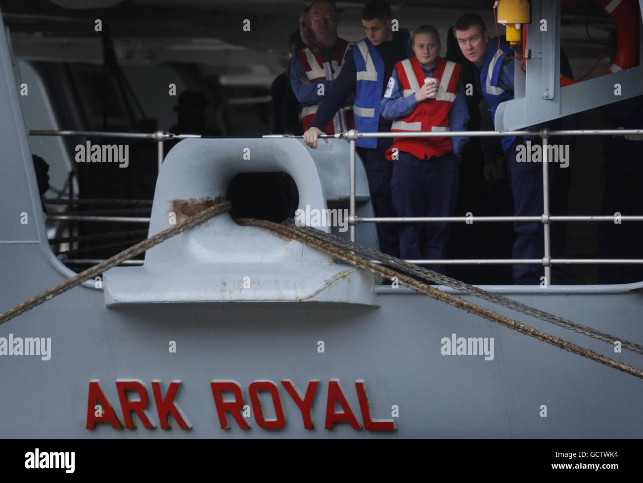 Crew onboard the Royal Navy aircraft carrier HMS Ark Royal as it docks ...