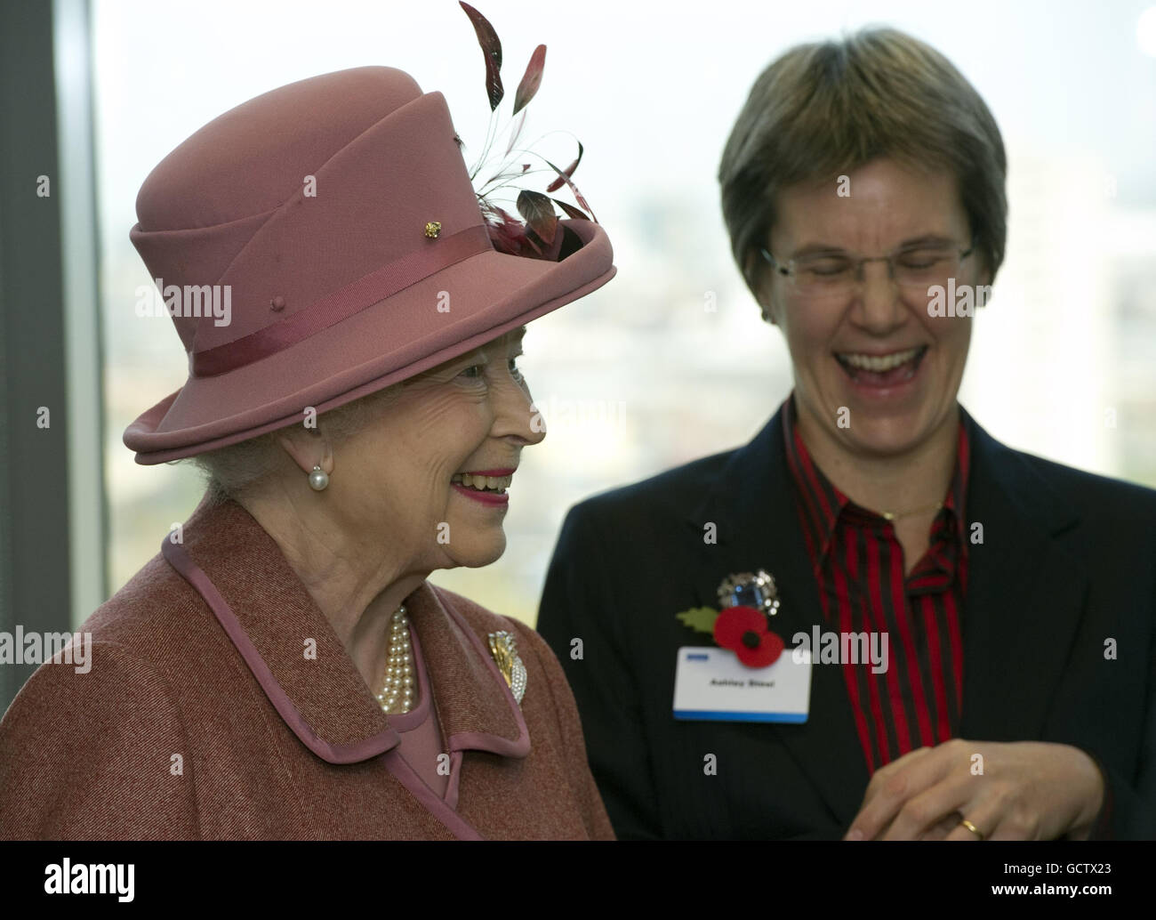 Queen Elizabeth II talks to staff members during a visit to mark the ...