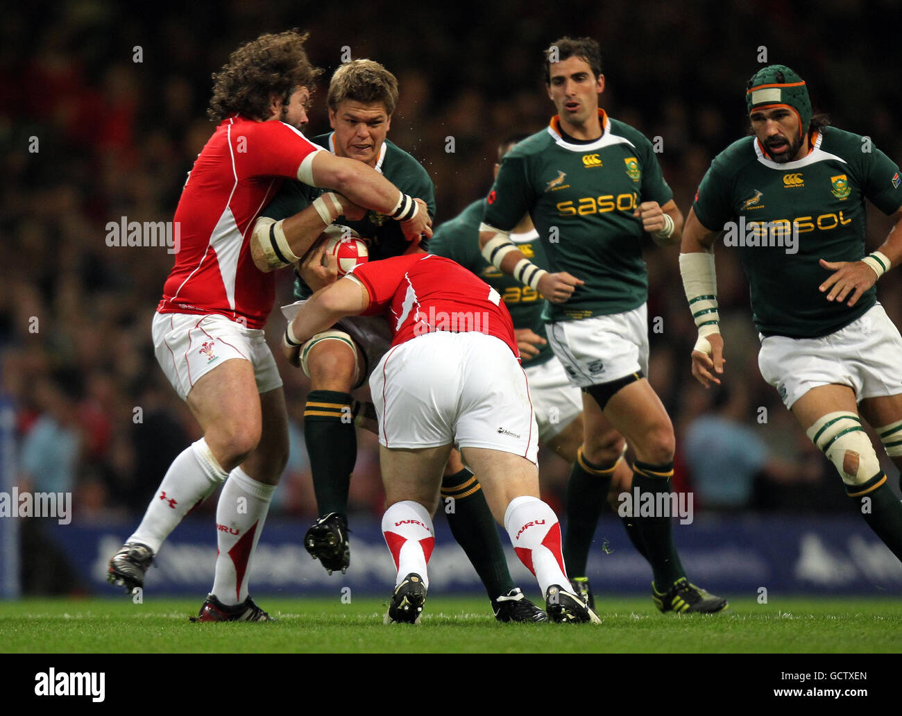 South Africa's Juan Smith is tackled by Wales' Adam Jones and Paul ...