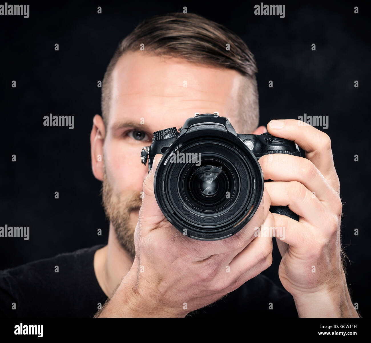 Photographer man with camera on darck background. Focus on camera Stock ...