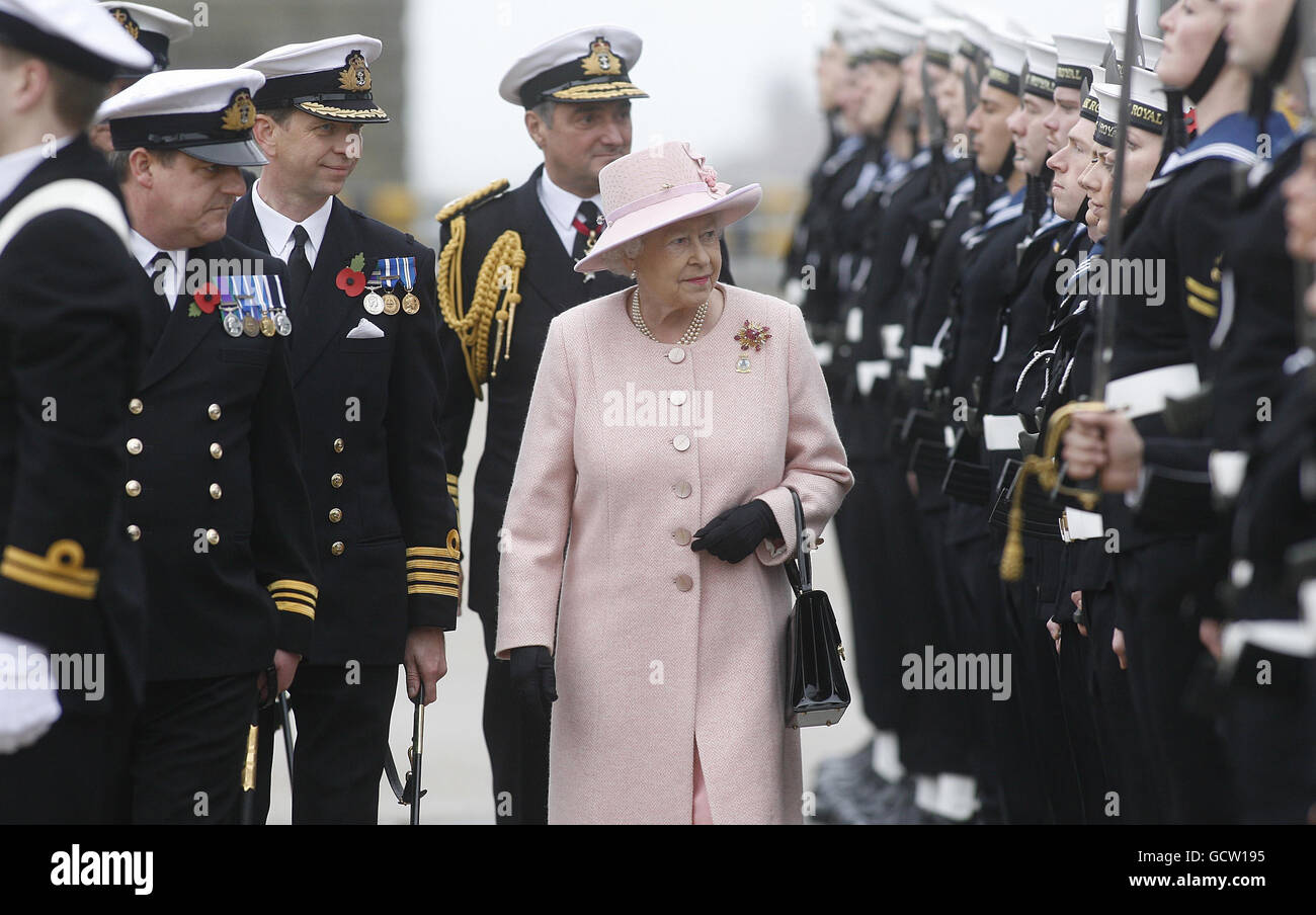 Queen Elizabeth II inspects the guard during a visit to HMS Ark Royal ...