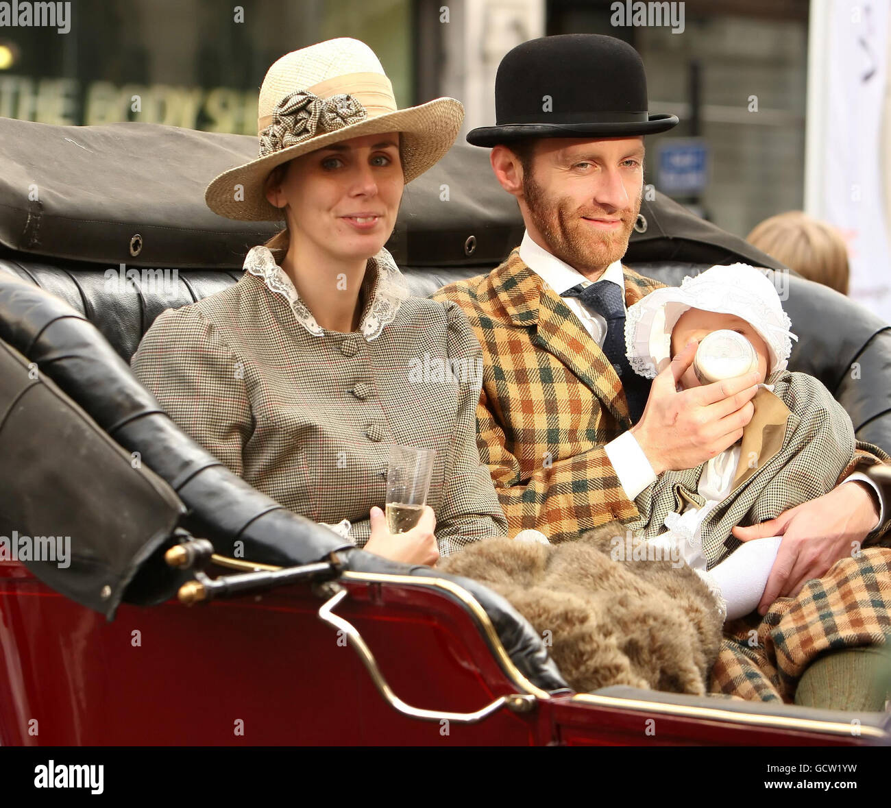 Marie and Andy Coburn, with their daughter Genevieve, sit in a 1905 ...