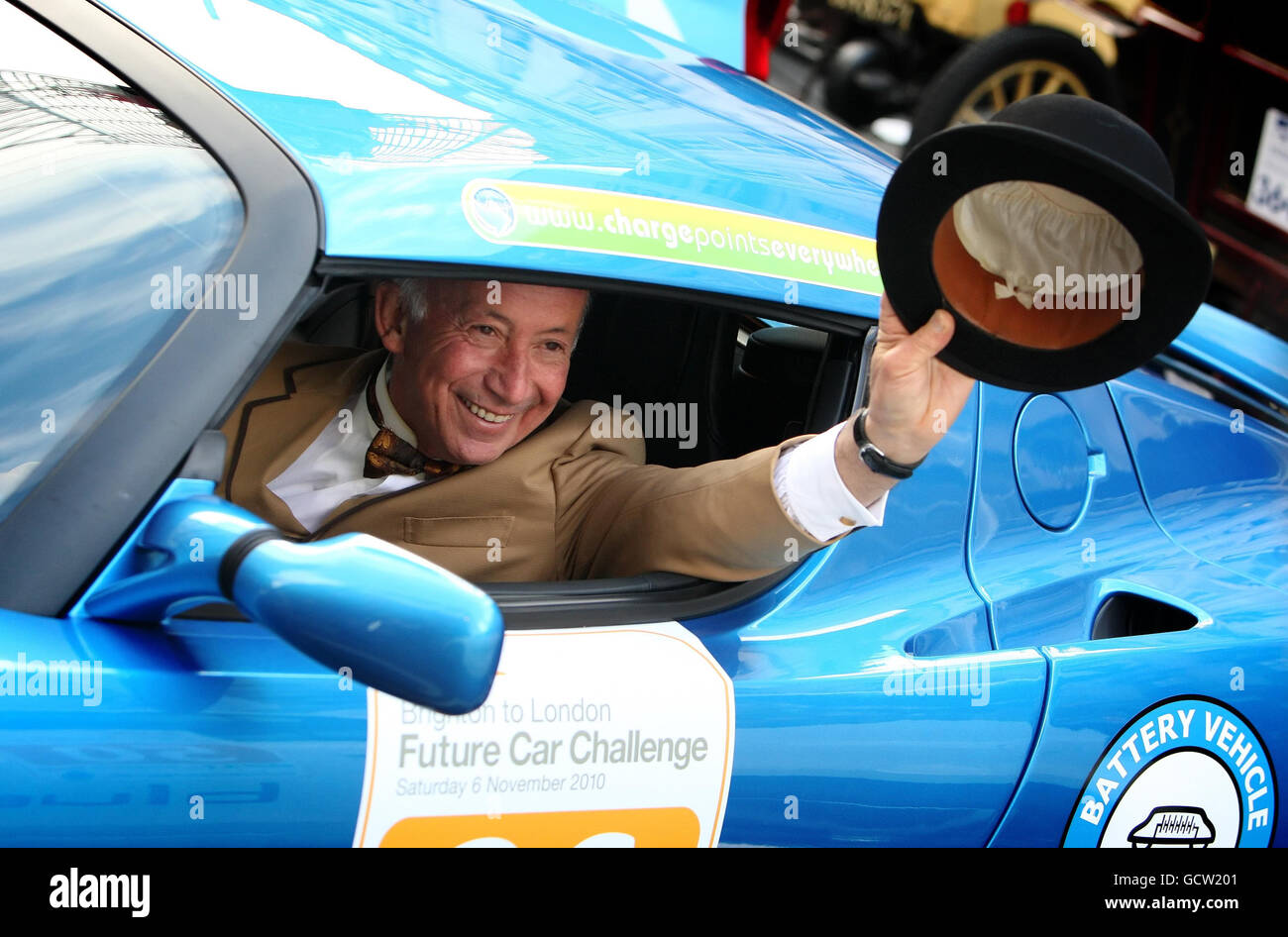 Gemmi Tommaso waves from the window of a Tesla electric car which is ...
