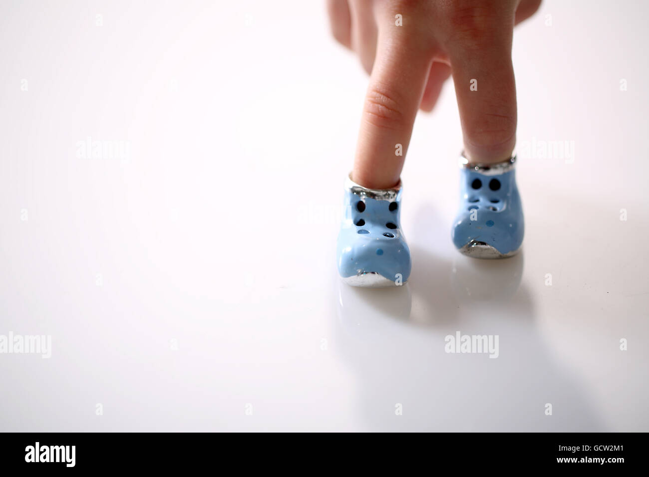 Small shoes on the white background Stock Photo - Alamy