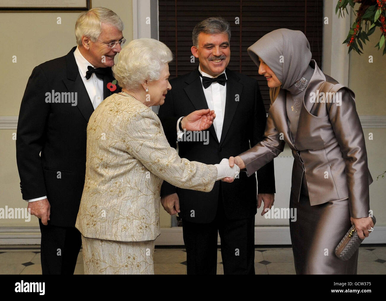 Britain's Queen Elizabeth II greets Hayrunnisa Gul, the wife of the ...