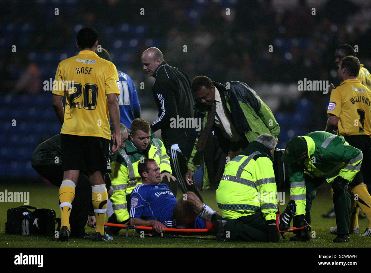 Peterborough United's David Hibbert lies injured before being taken off ...