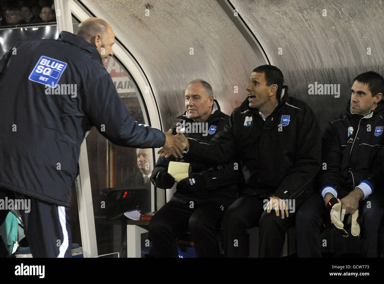 Woking's manager Graham Baker shakes hands with Brighton manager Gus ...