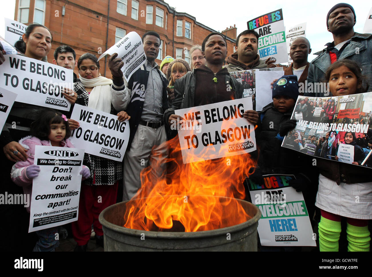 Protesters hold up banners during the Anti-UK Borders Agency ...