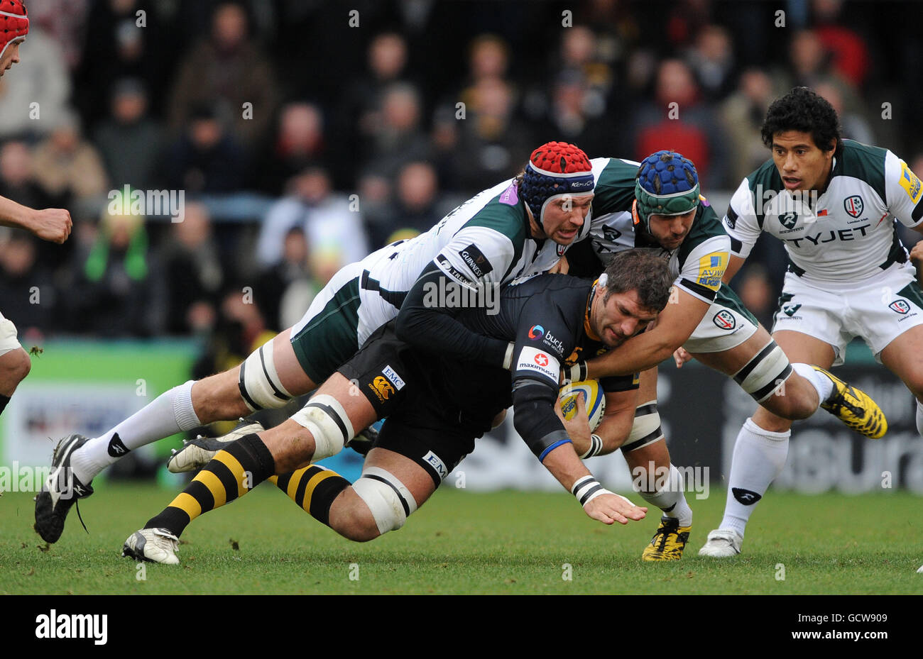 London Wasps' Simon Shaw is tackled by London Irish's Nick Kennedy ...