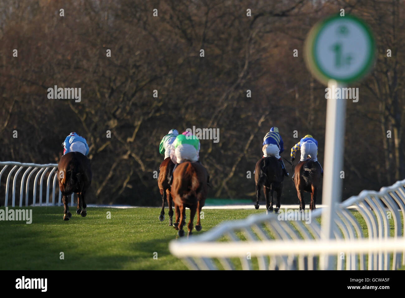 Runners and riders pass the one furlong marker hi-res stock photography ...
