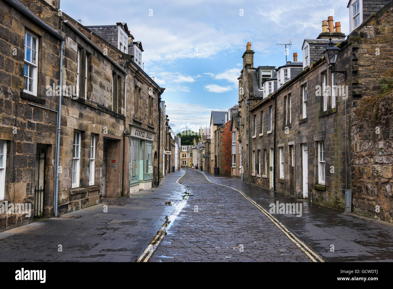 Cobblestone trail in the middle of a street running between rows of ...