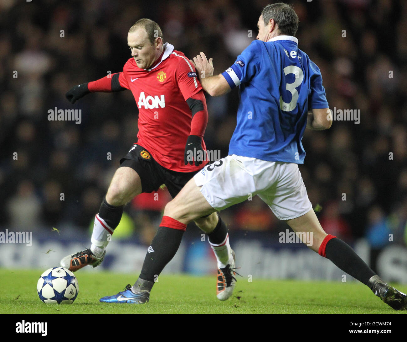 Manchester United's Wayne Rooney and Rangers David Weir battle for the ...