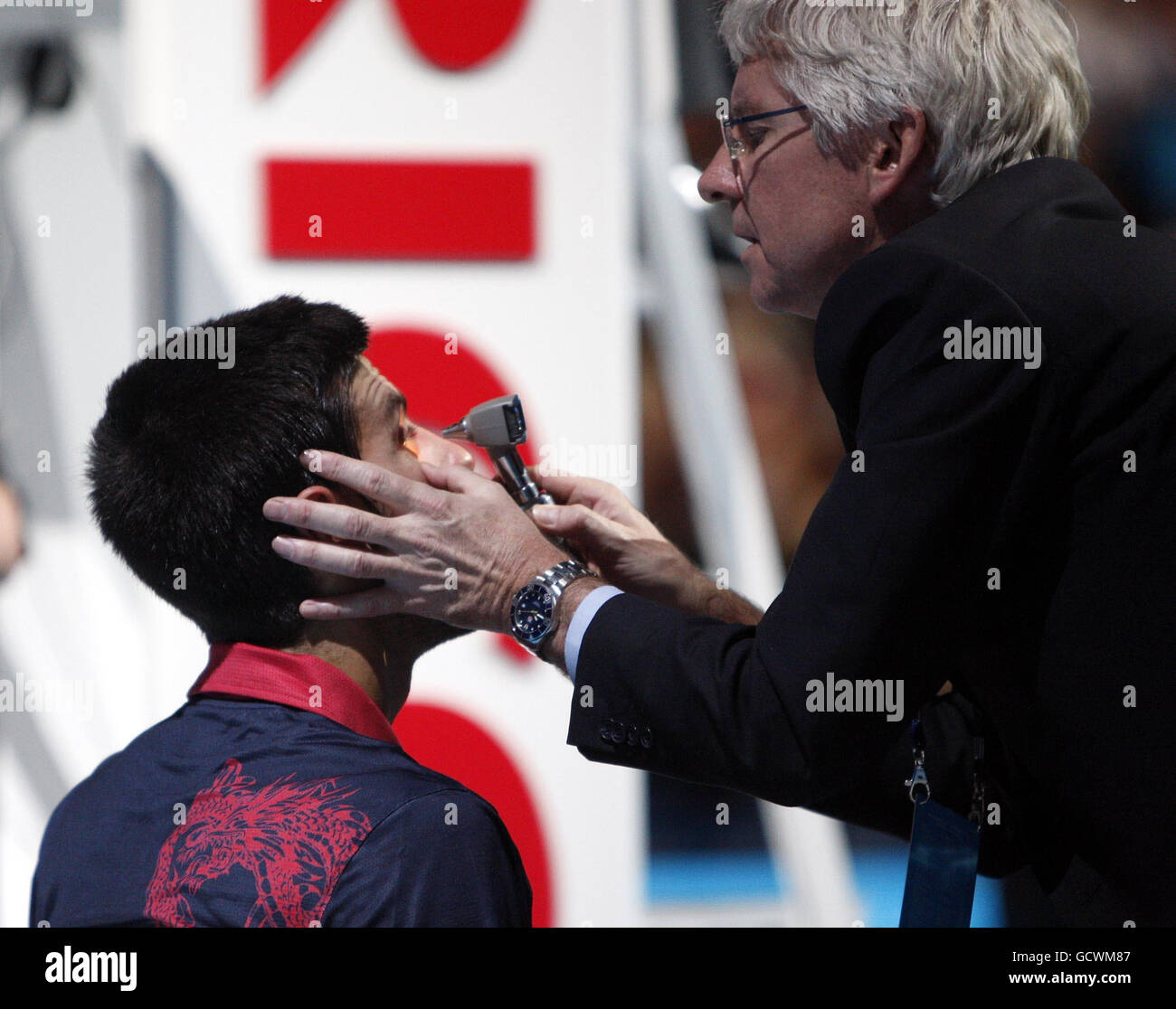 Serbia's Novak Djokovic has his eye inspected during day four of the ...