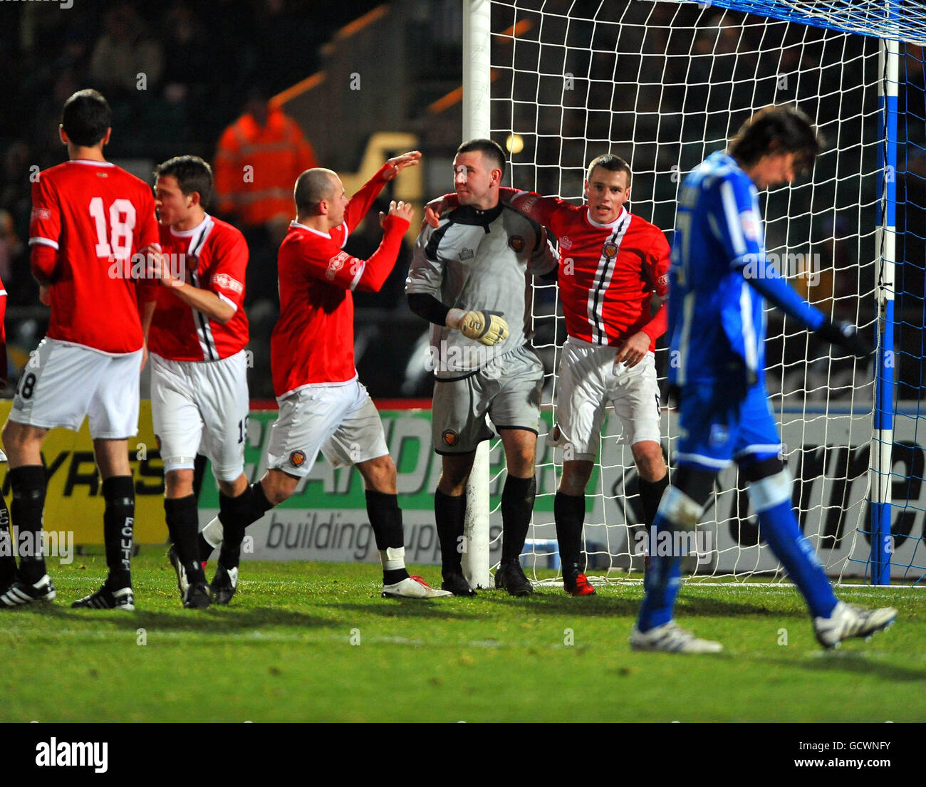 FC United of Manchester's Sam Ashton is congratulated after saving ...