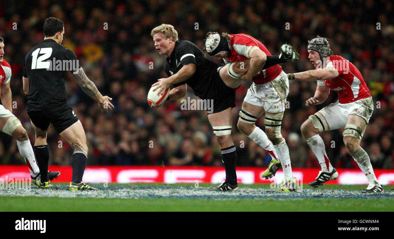 New Zealand's Daniel Braid is tackled by Wales's Jonathan Thomas during ...