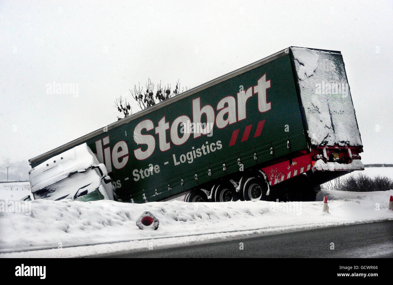 A lorry comes to rest in a ditch after leaving the road during ...