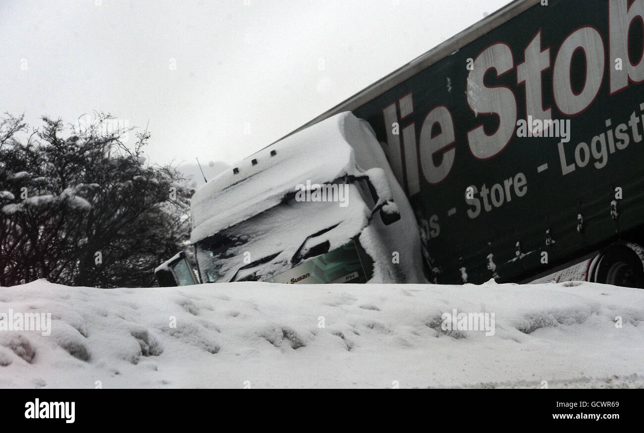 A lorry comes to rest in a ditch after leaving the road during ...