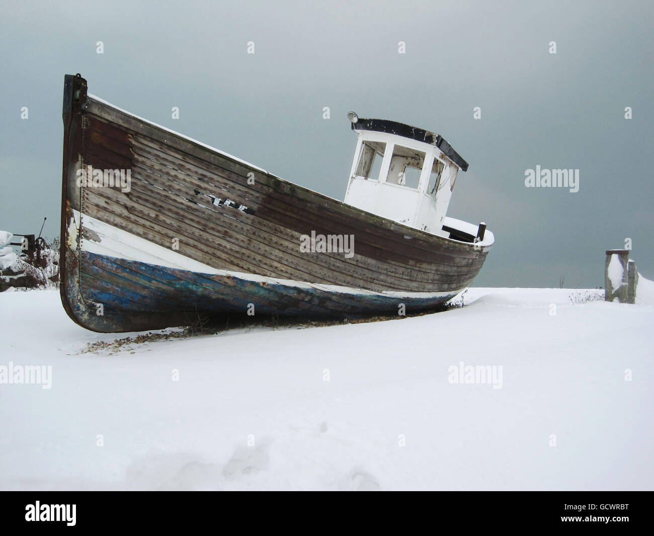A boat sits on a snow covered beach in Eastbourne, East Sussex, as snow ...