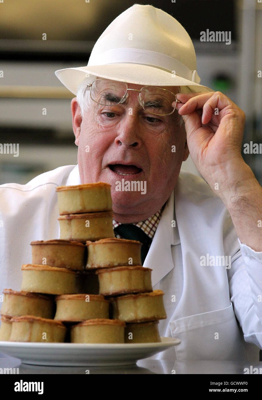 Judge Jim Lamond inspects a plate of pies during the World Scotch Pie ...