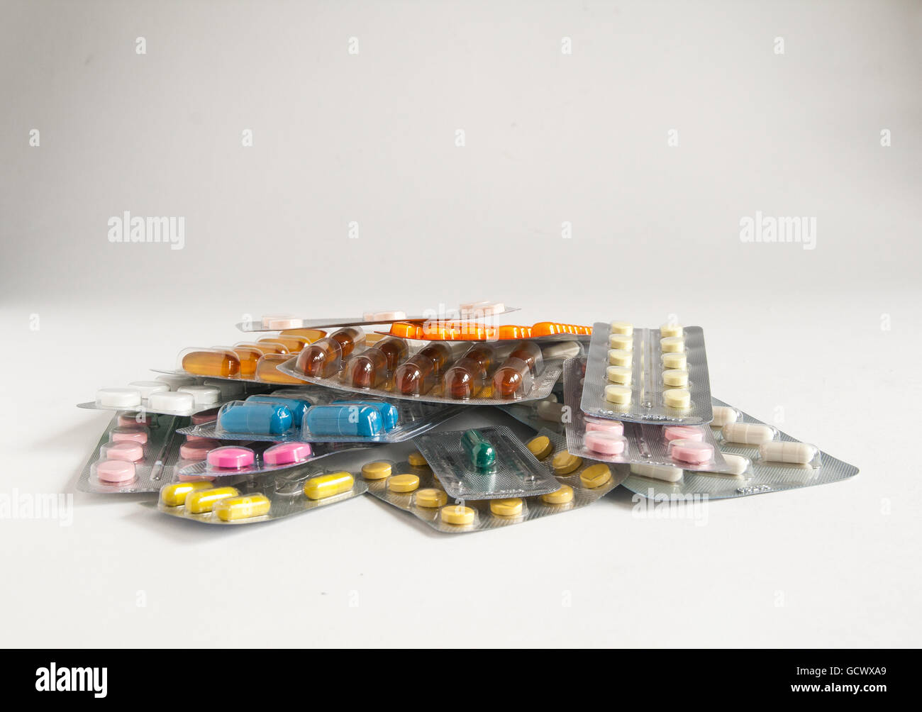 Stack of pills on a white background Stock Photo - Alamy